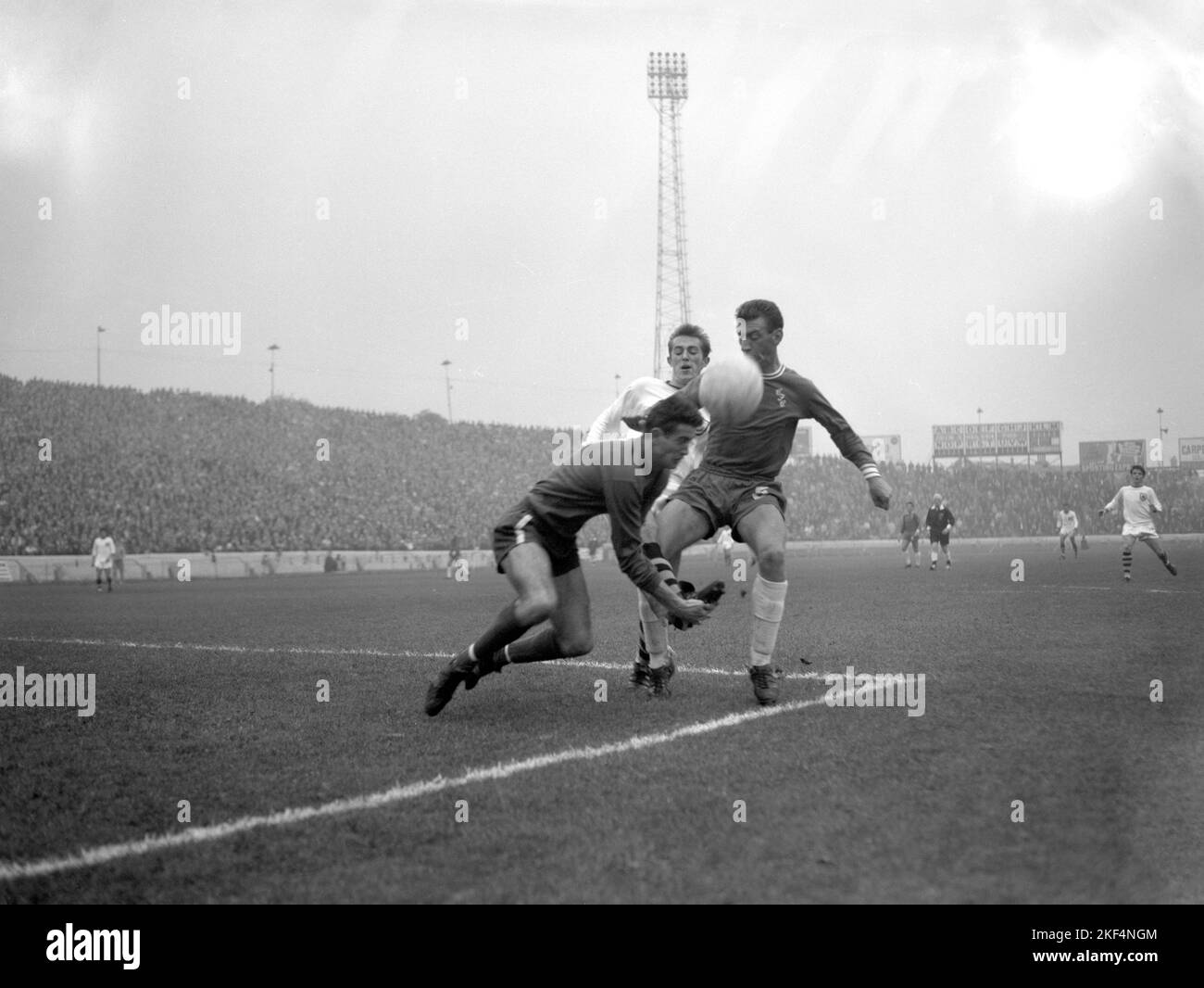 Chelsea goalkeeper Peter Bonetti clashes with teammate Mortimor (r) and ...