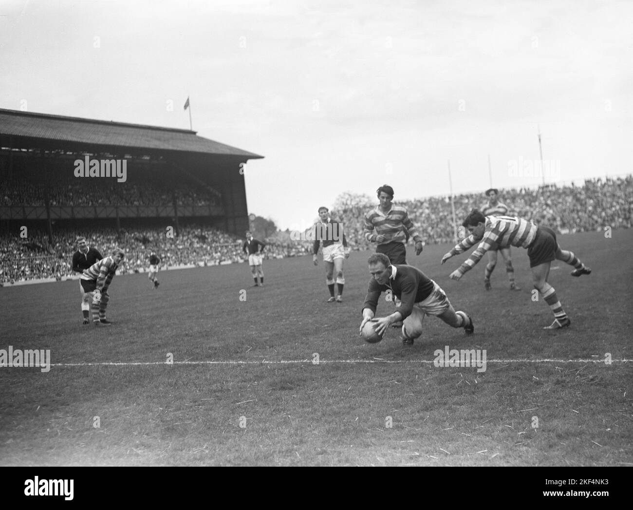 Hugh McLeod scores a try for Hawick despite the attention of Rosslyn ...