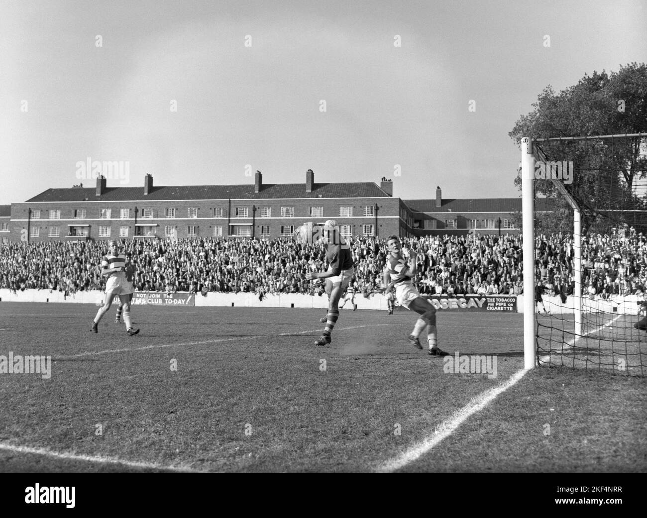 Wrexham goalkeeper Rolando Ugolini, wearing a jockey cap, saves from ...