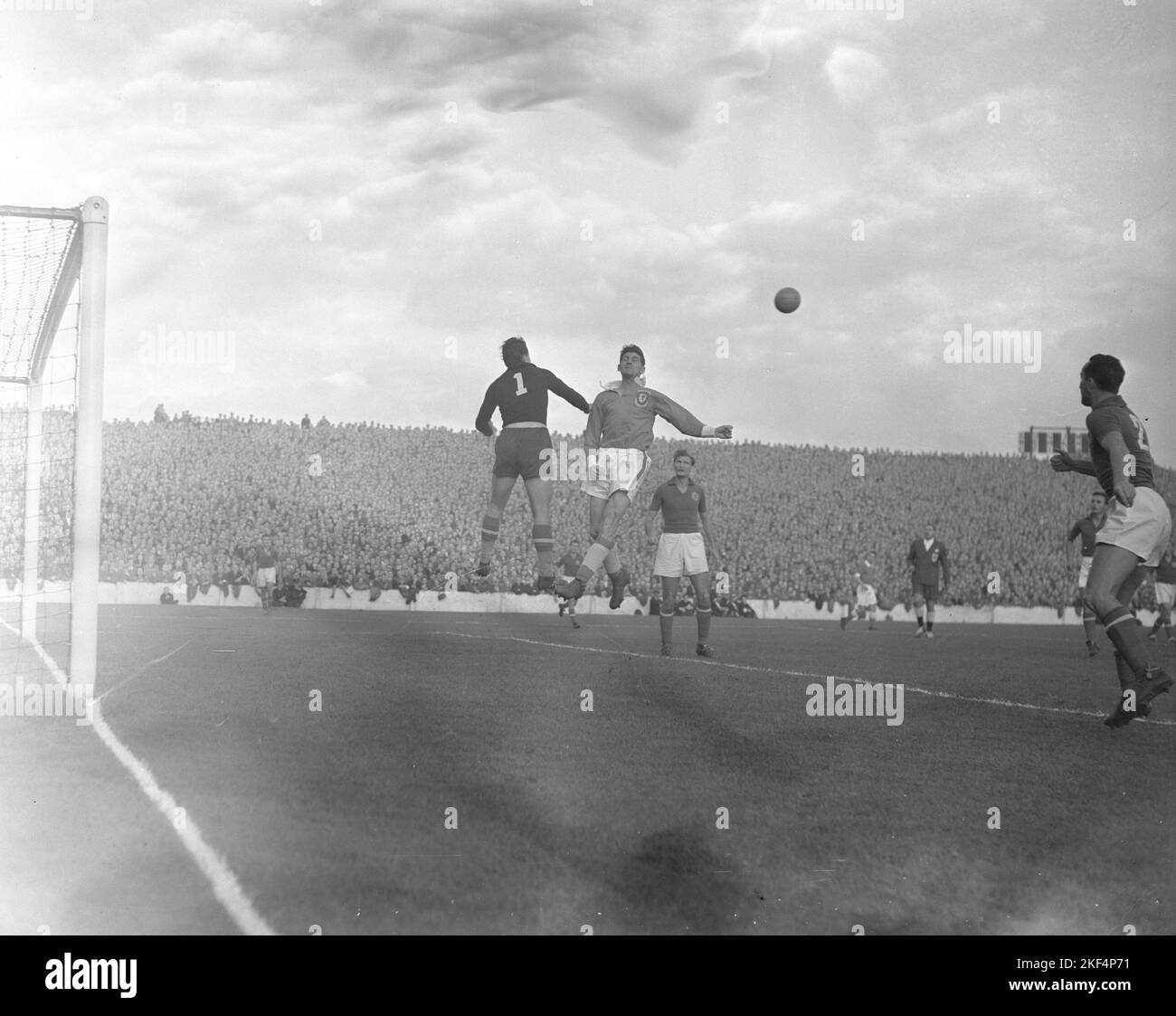 Vladimir Beara (Yugoslav goalkeeper) just punches away as Trevor Ford ...