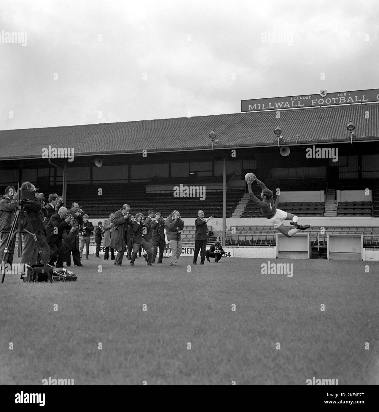 Millwall Goalkeeper Brian King, watched by the many press photographers ...