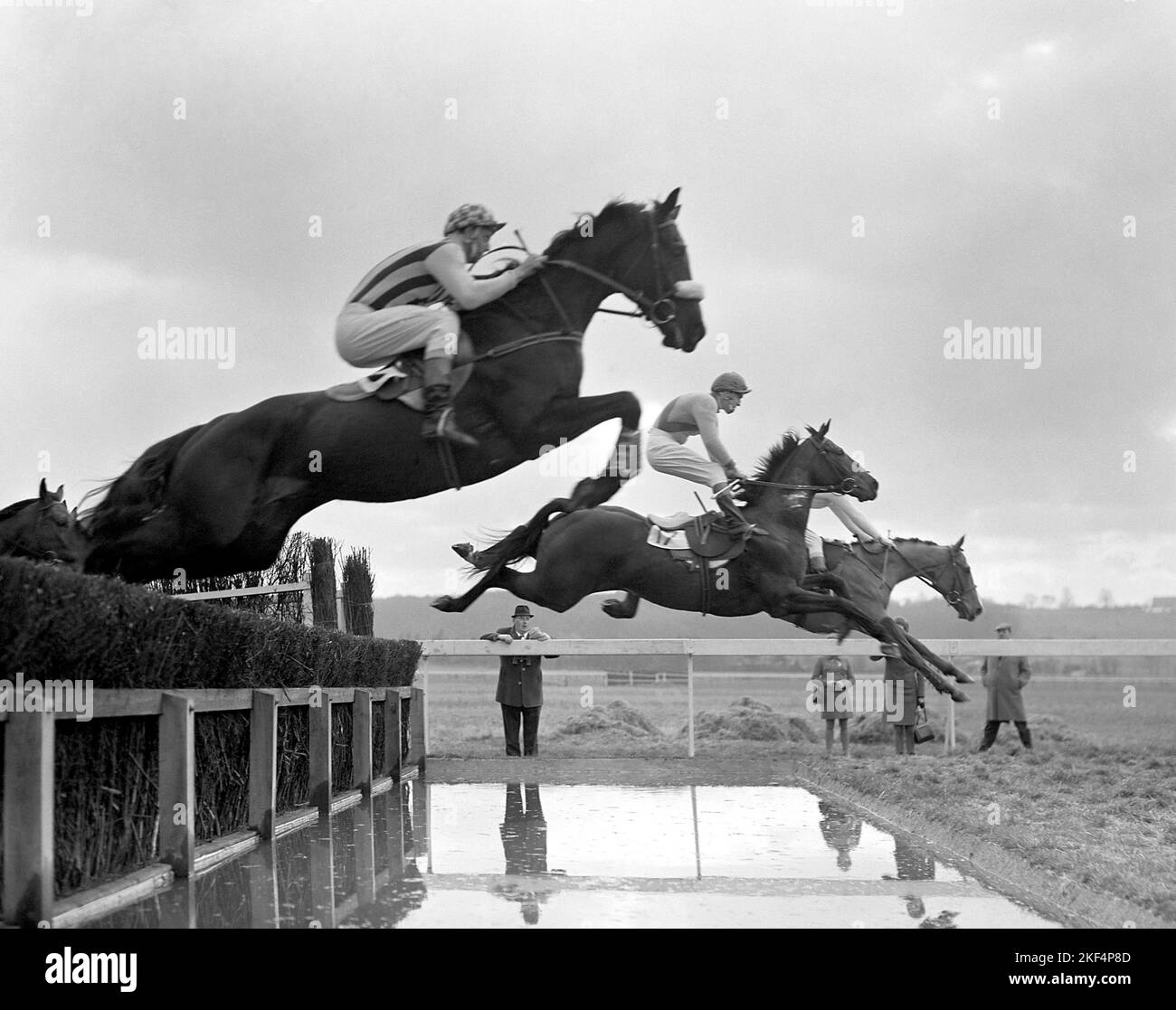 Taking the water jump (Left to Right) Jockey D. Moore on Simian, Jockey ...