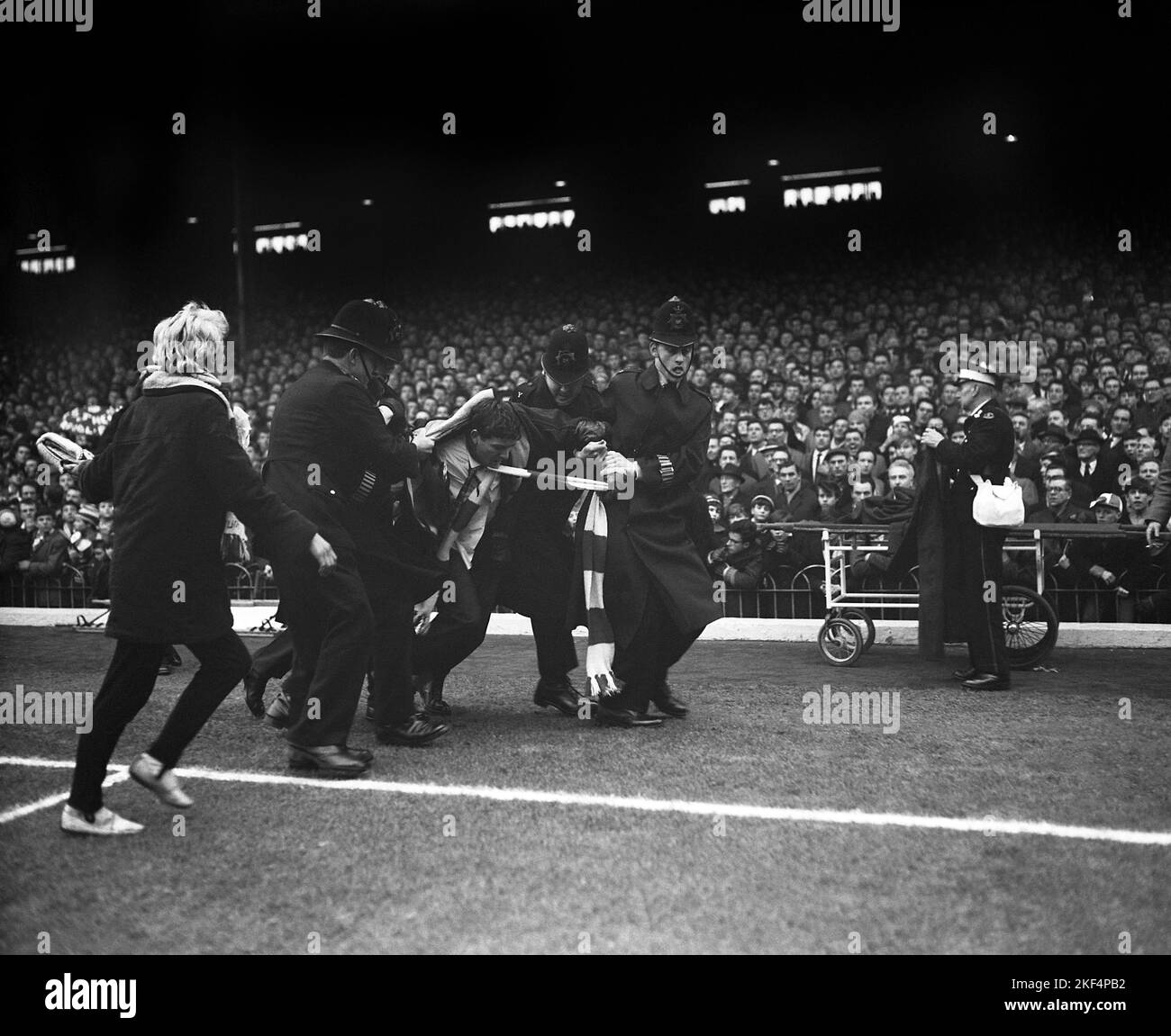 Police drag away a spectator following an incident before the start of ...
