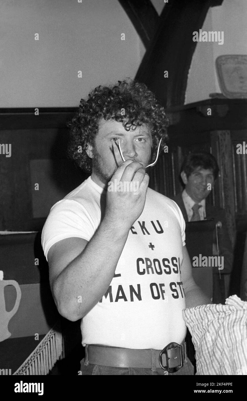 British strongman Allan Crossley bending steel ties Stock Photo - Alamy