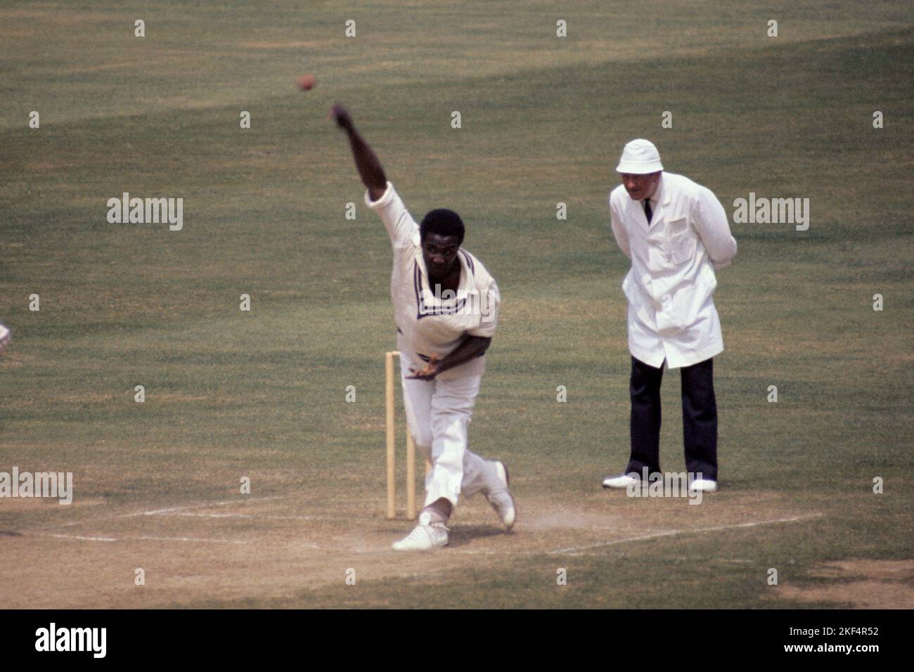 Middlesex's Wayne Daniel bowls, watched by umpire Dusty Rhodes Stock ...