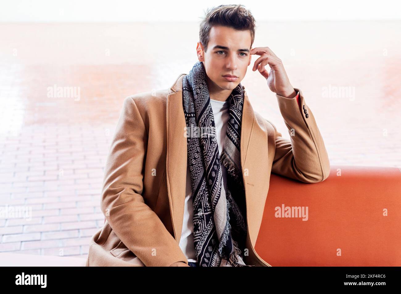 Young man wearing winter clothes in the street. Young guy with modern ...