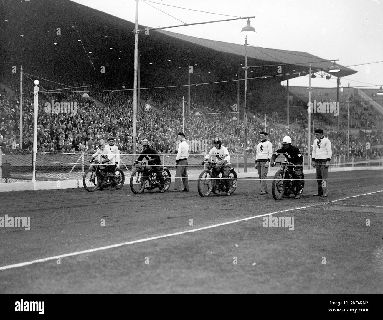 Two riders from each team line up behind Wembley's new starting gate at ...