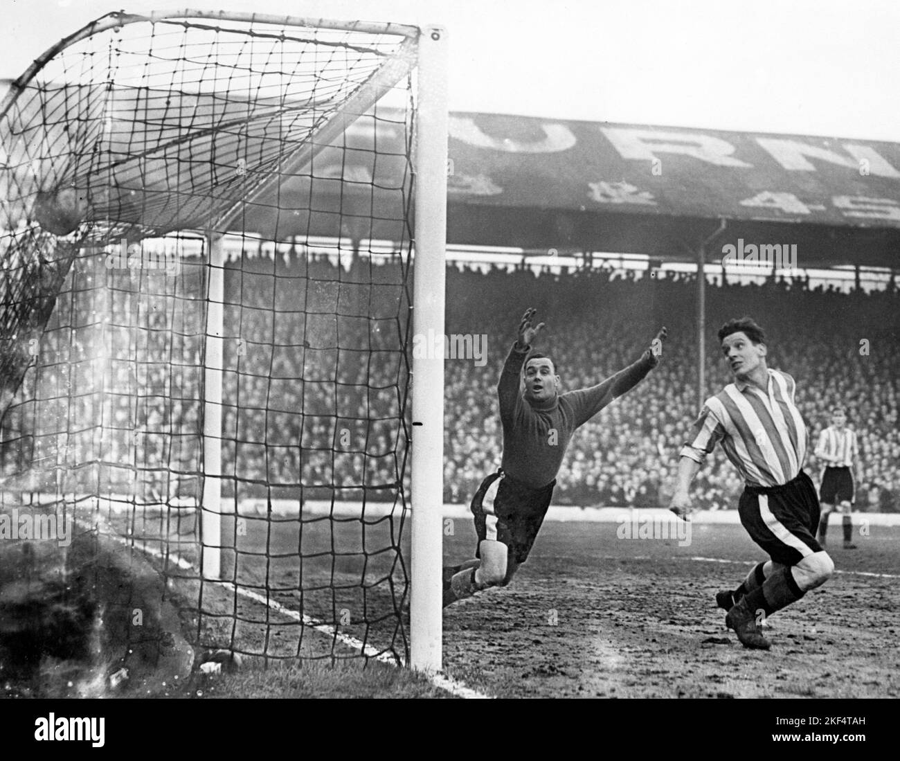 Brentford goalkeeper Ted Gaskell and defender Ken Horne can only watch ...