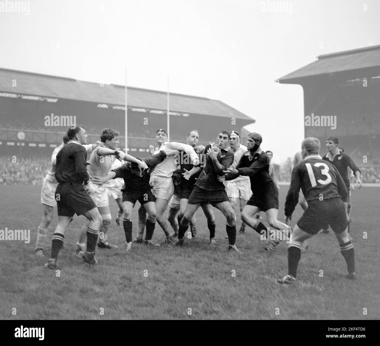 New Zealand's Colin Meads (c) emerges from a loose maul with the ball ...