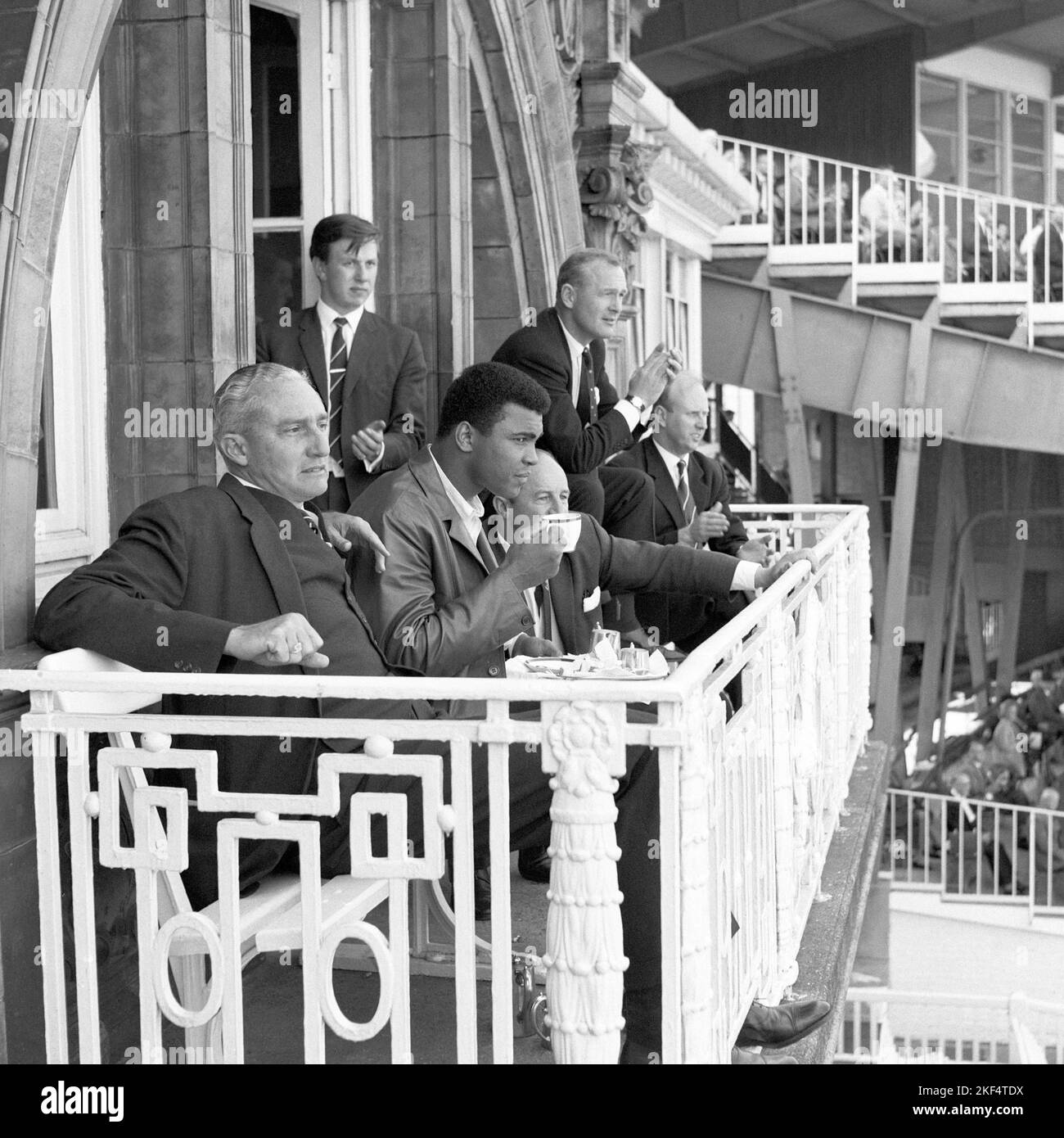 World Heavyweight Boxing Champion Muhammad Ali (second l) sips a cup of ...