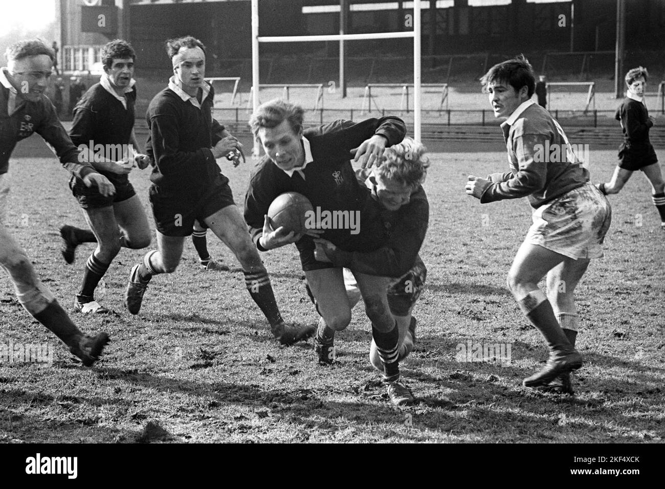 Dave Spawforth, Army scrum half, looks on as A. D. Hoon tackles the ...
