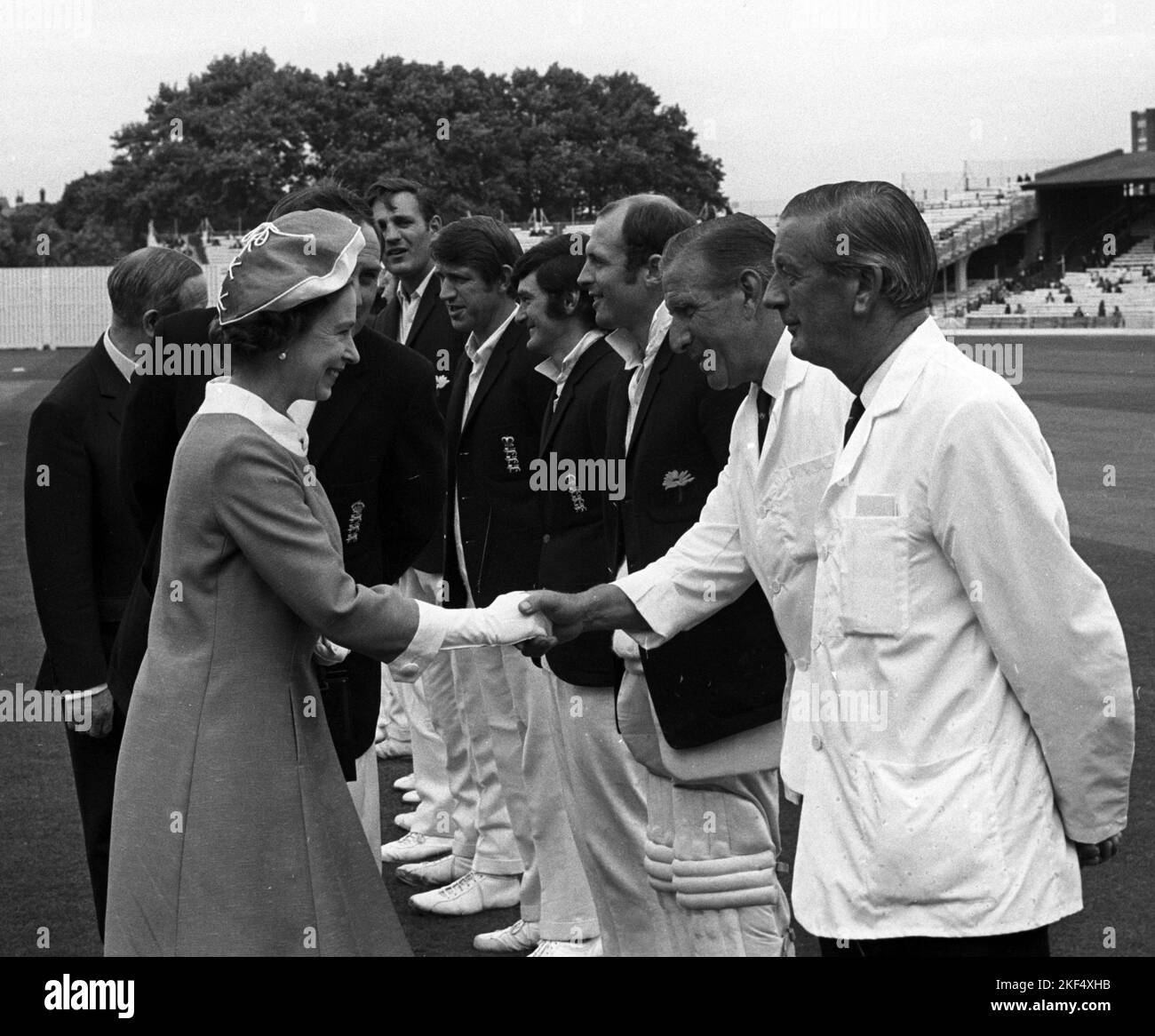 Queen Elizabeth II shakes the hand of umpire Arthur Fagg as she is ...
