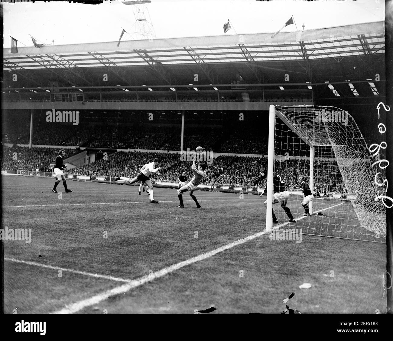 England's Martin Peters (second l) heads the first goal past Scotland ...