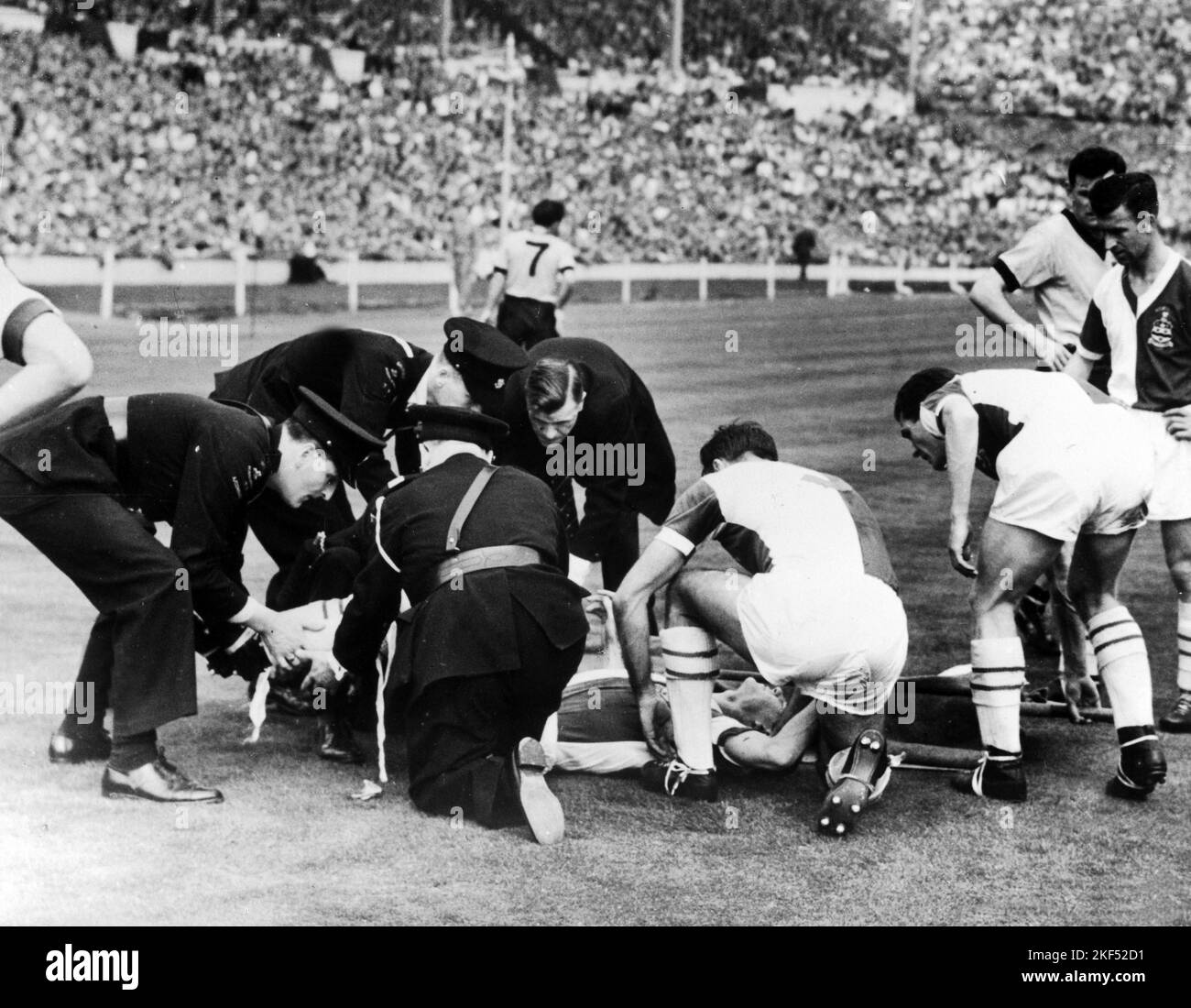 Blackburn Rovers' Dave Whelan lies injured as ambulance men attempt to ...