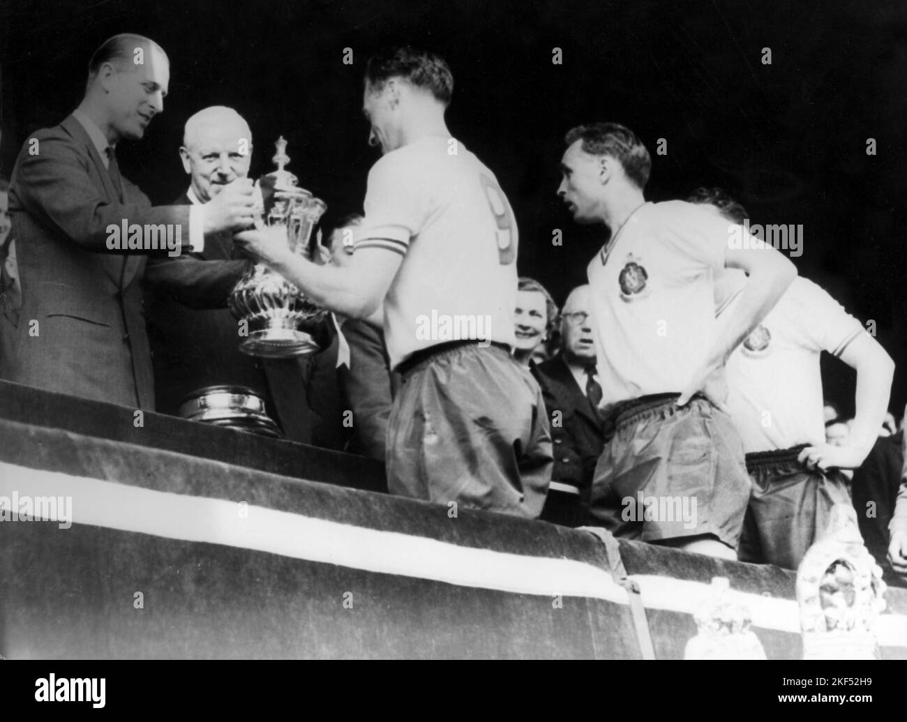 Bolton Wanderers captain Nat Lofthouse (c) receives the FA Cup from ...