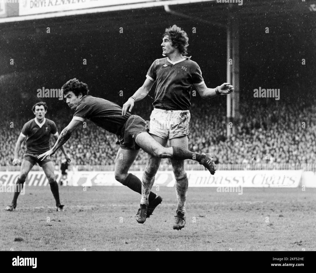 Liverpool's Kevin Keegan (l) is challenged by Everton's Mick Lyons (r ...