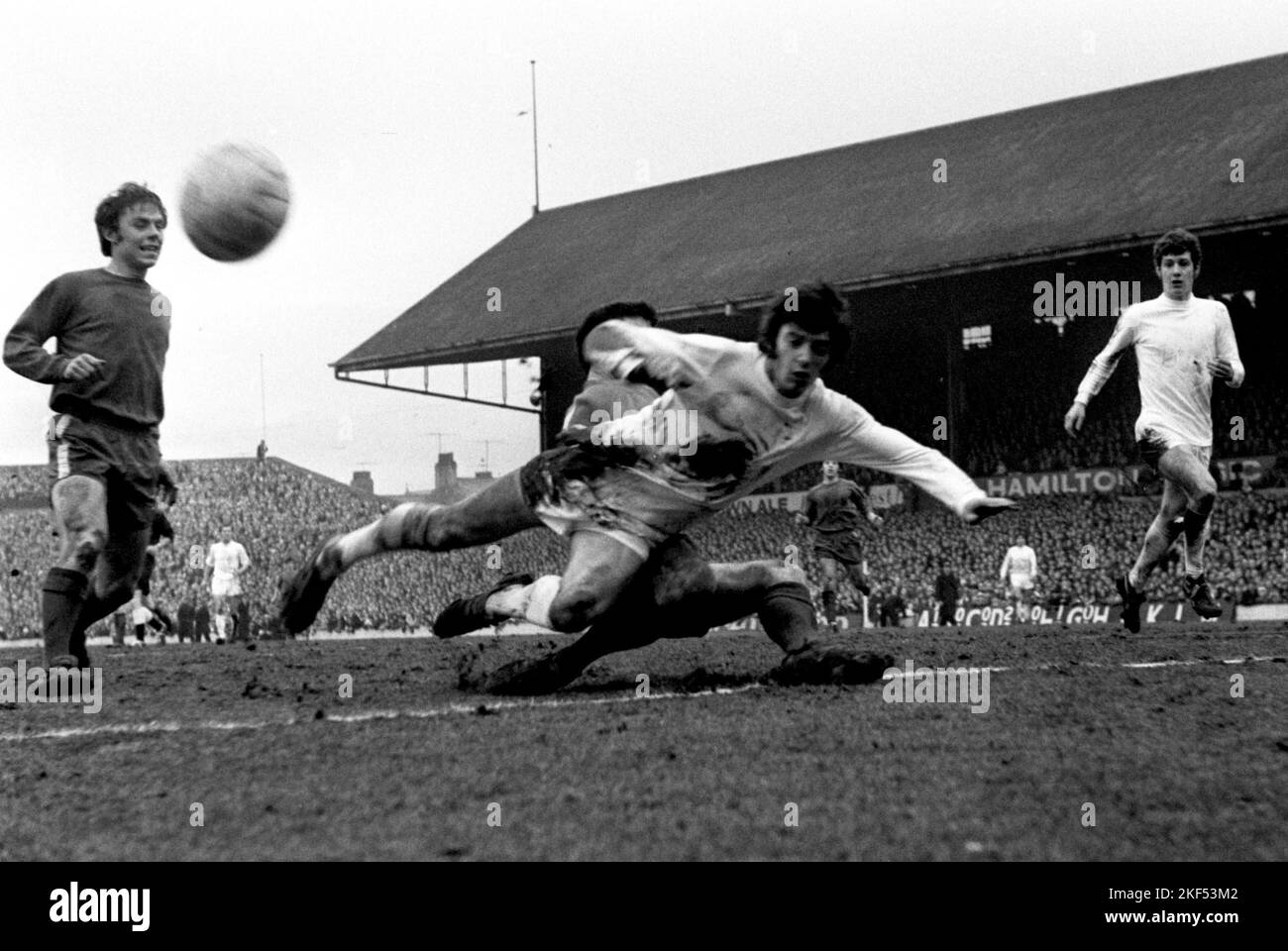 Manchester United's Willie Morgan is sent sprawling after the challenge ...