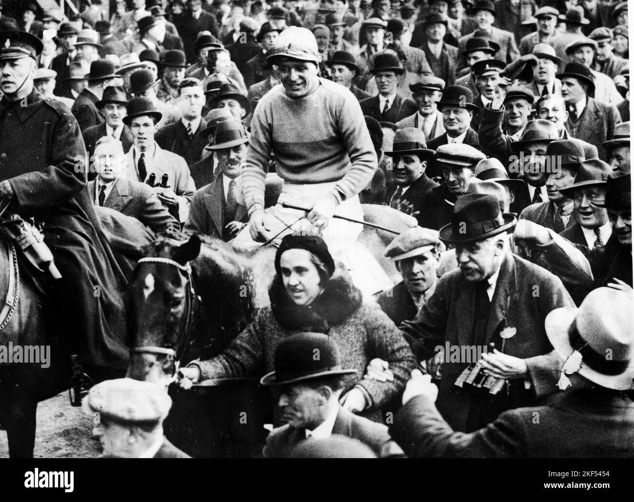 Gerry Wilson on Golden Miller is led in by owner Miss Dorothy Paget ...