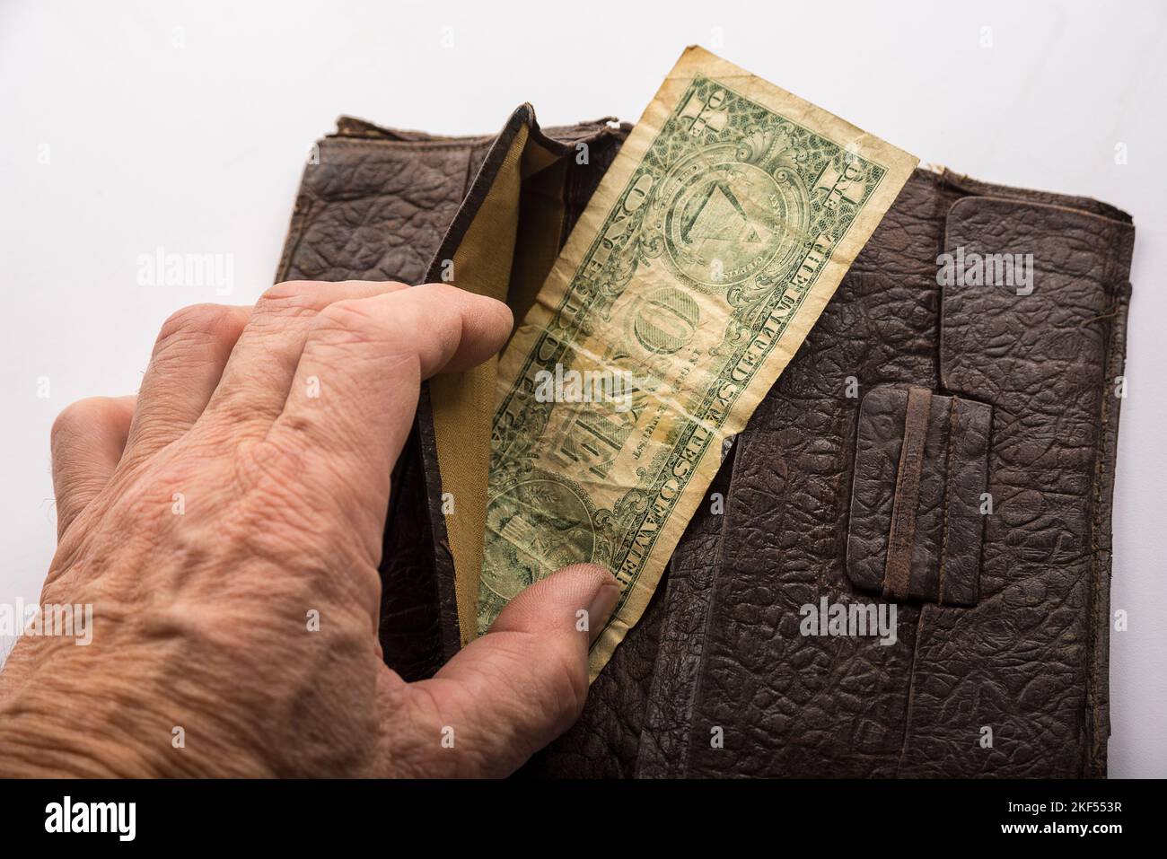 Poor pensioner torn wallet with one dollar Stock Photo - Alamy
