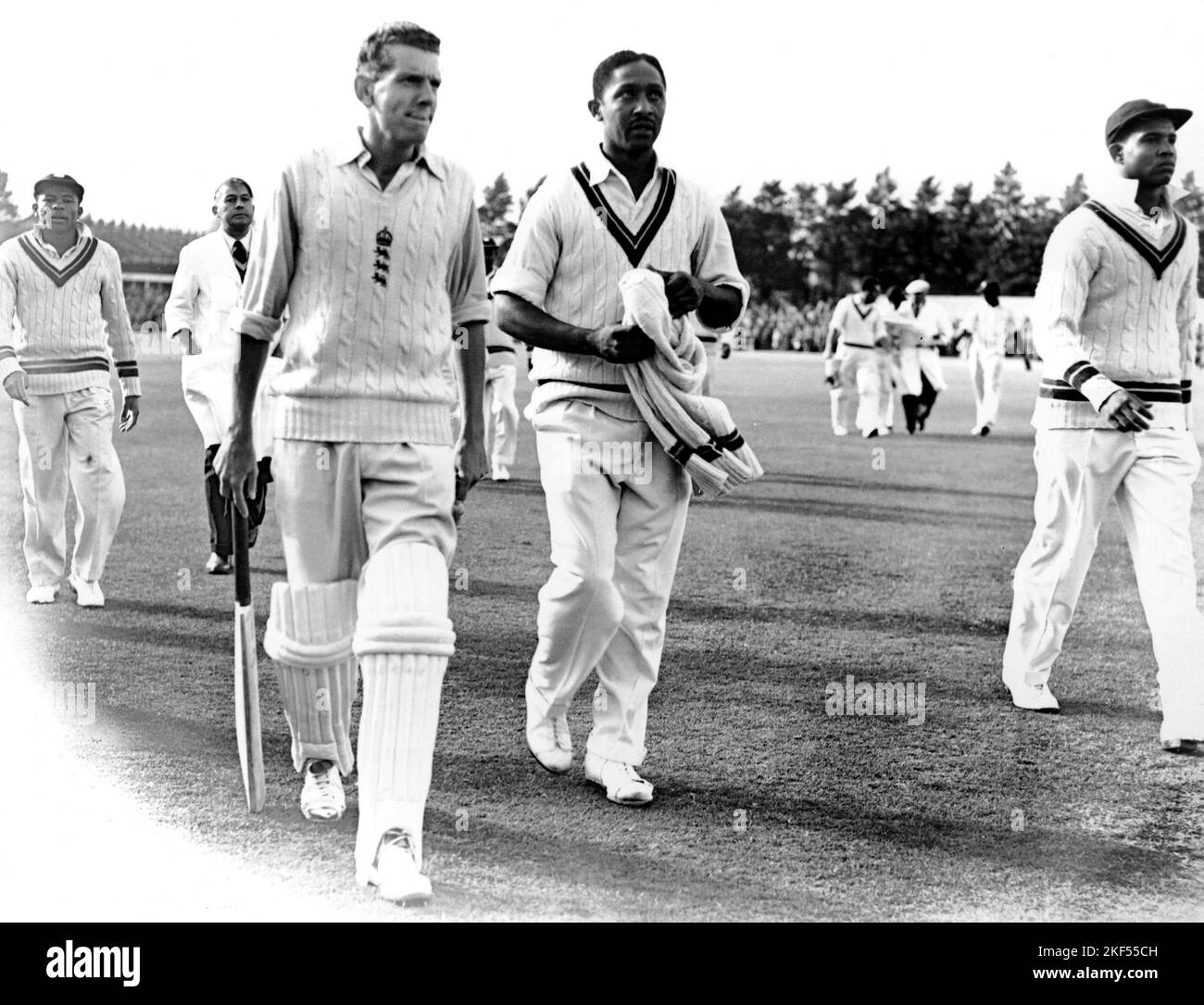 West Indies' Frank Worrell (r) and England's Peter Loader (l) return to ...
