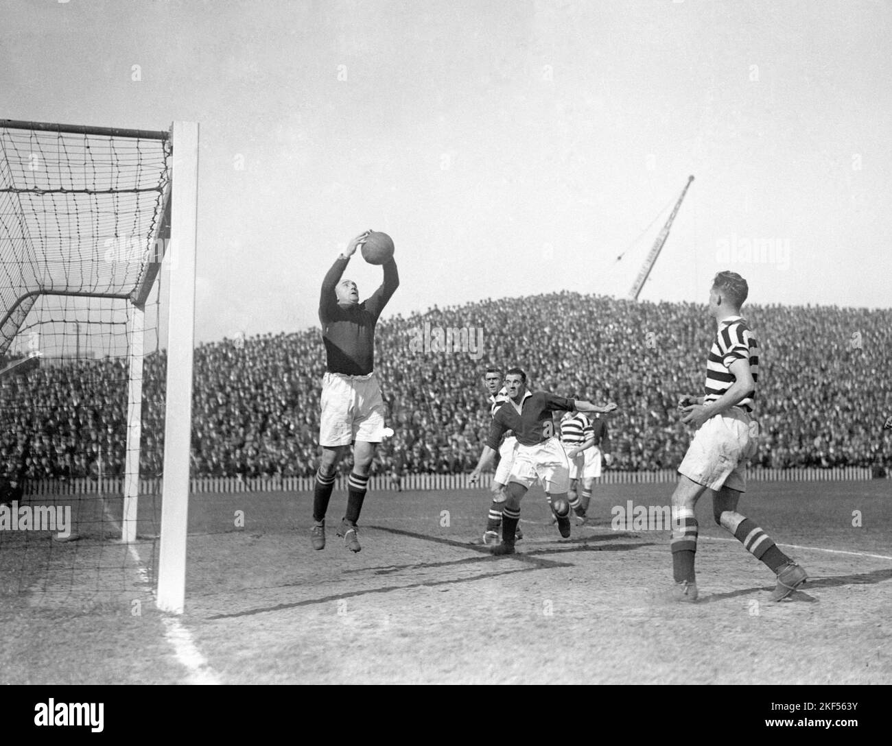 Manchester United goalkeeper John Hacking (left) claims the ball Stock ...