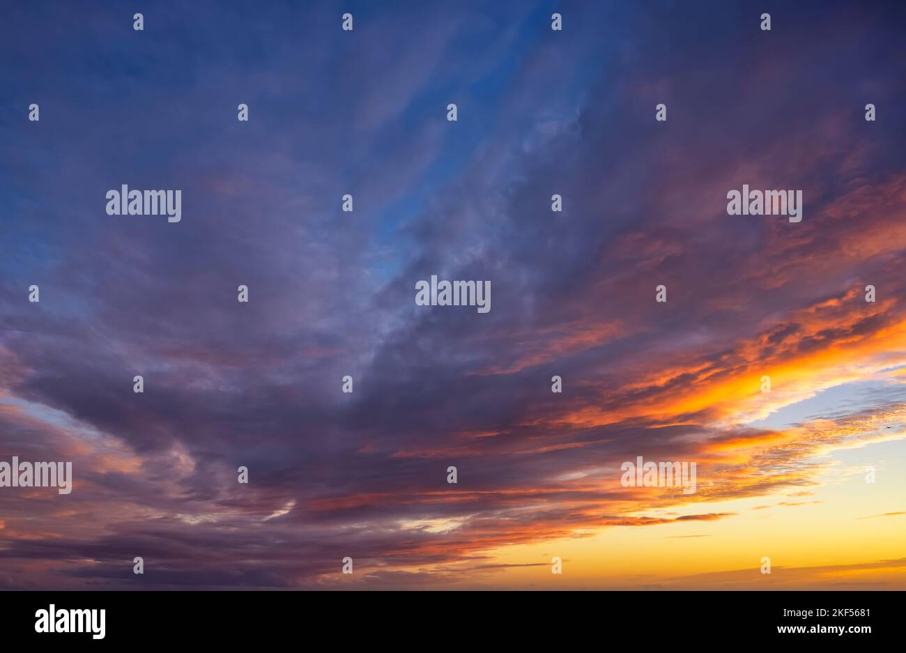 A vibrant sunset sky with orange, magenta and blue colors Stock Photo ...