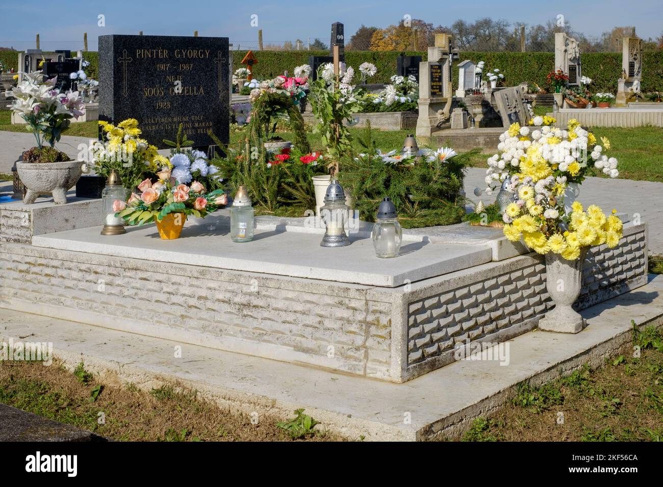 graves are decorated with fresh flowers candles lanterns at local rural ...
