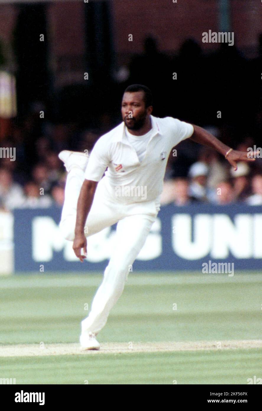 West Indies' Malcolm Marshall (r) follows through after bowling Stock ...