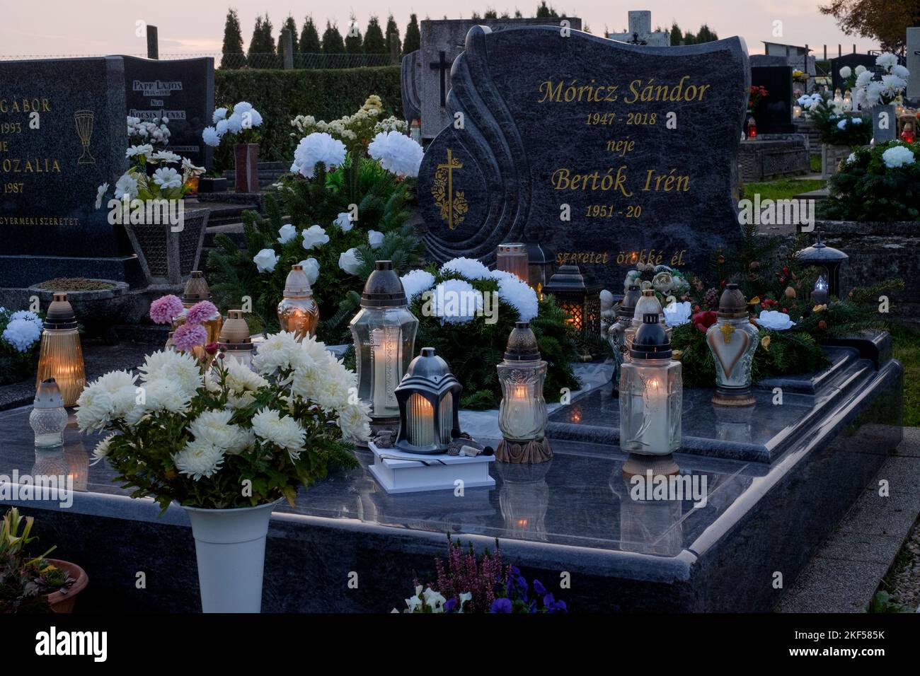graves are decorated with fresh flowers candles lanterns at local rural ...