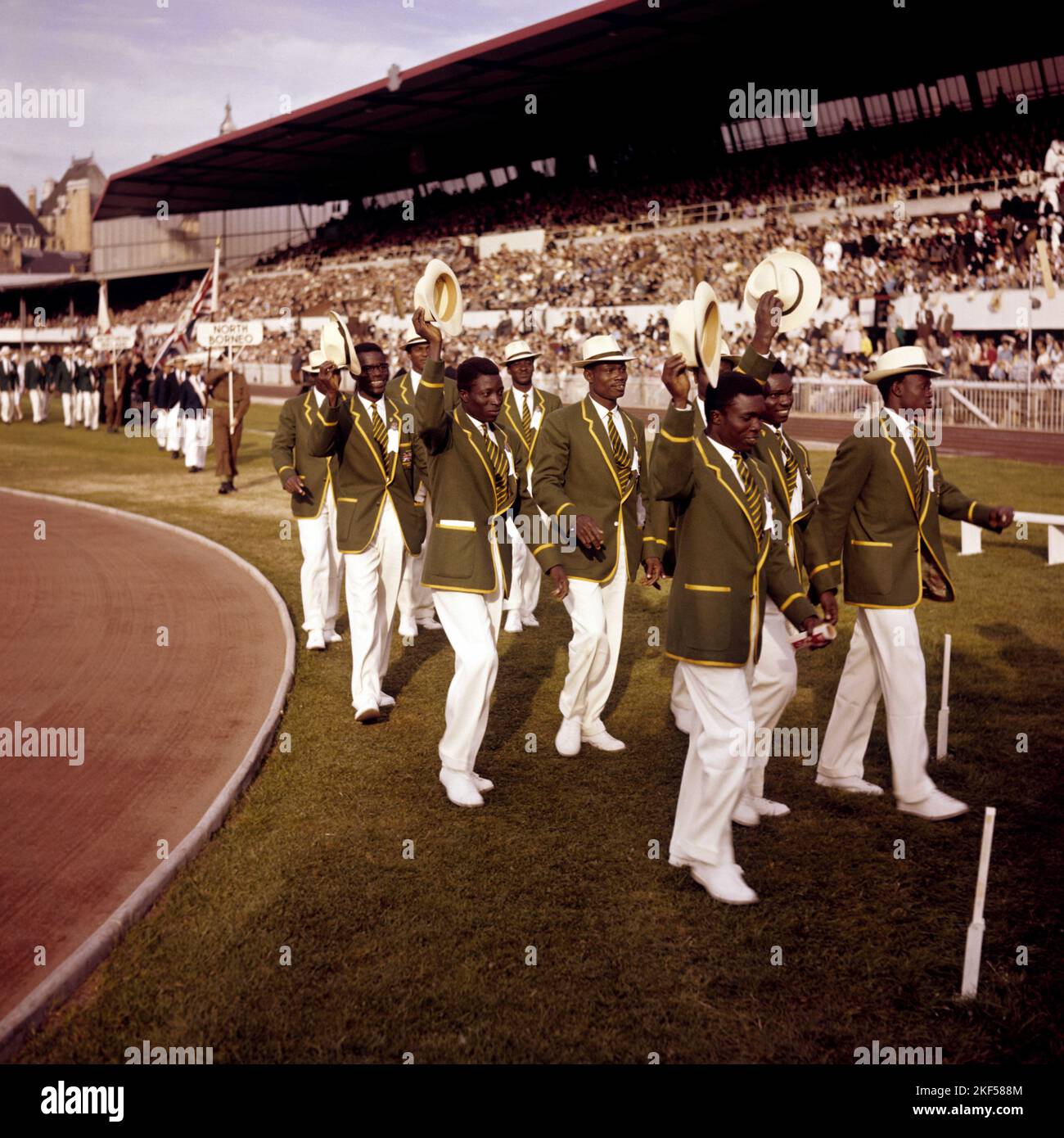 The Nigerian team, marching out of the stadium, raise their hats in ...