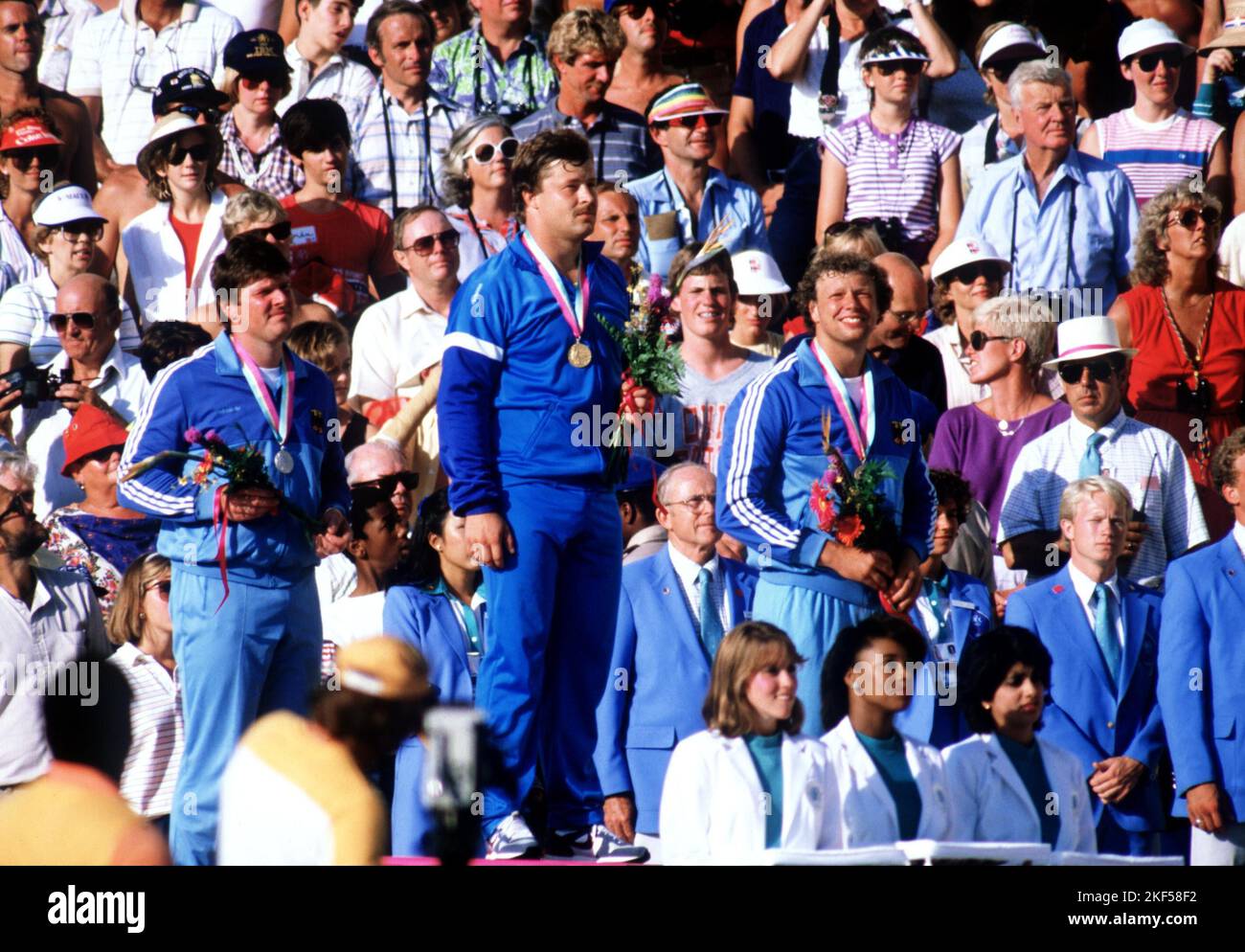 (L-R) The three medallists stand for the national anthems after ...