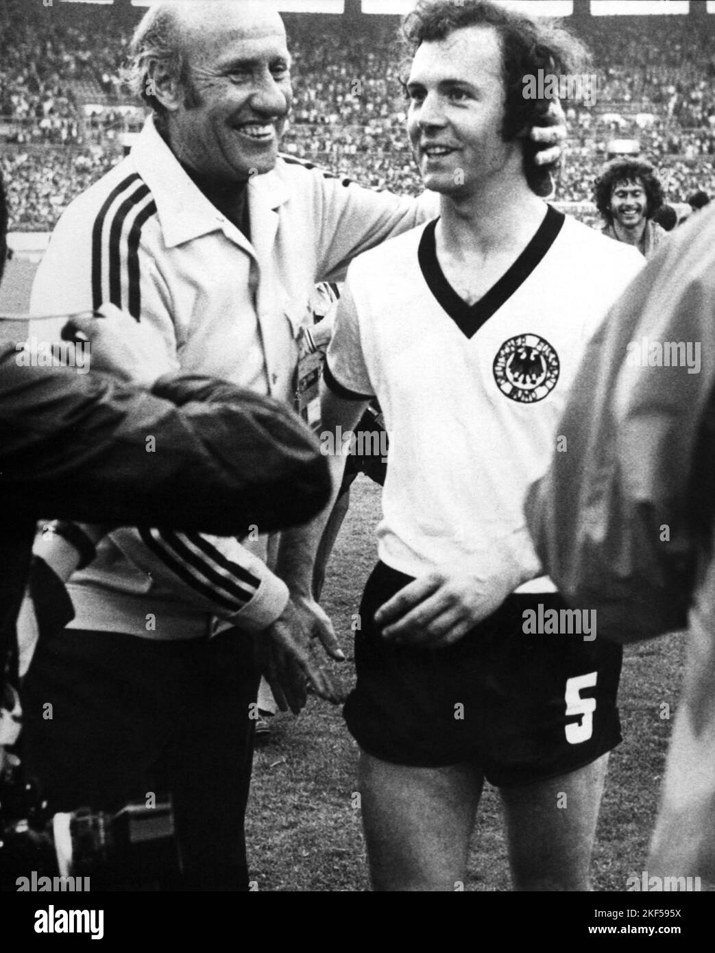 (L-R) West Germany Coach Helmut Schon congratulates captain Franz ...
