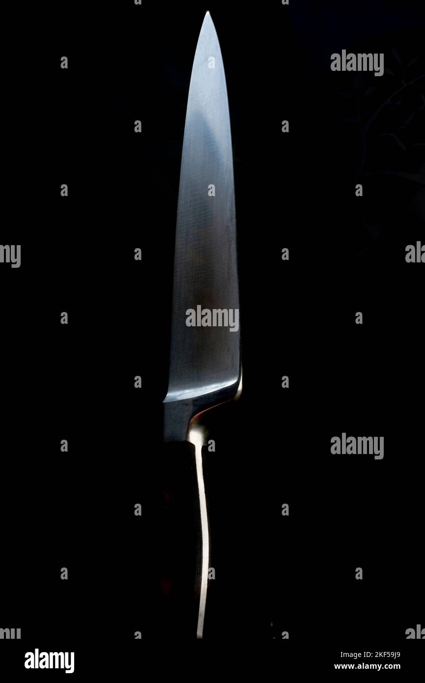 photograph of a kitchen knife on a black background Stock Photo - Alamy