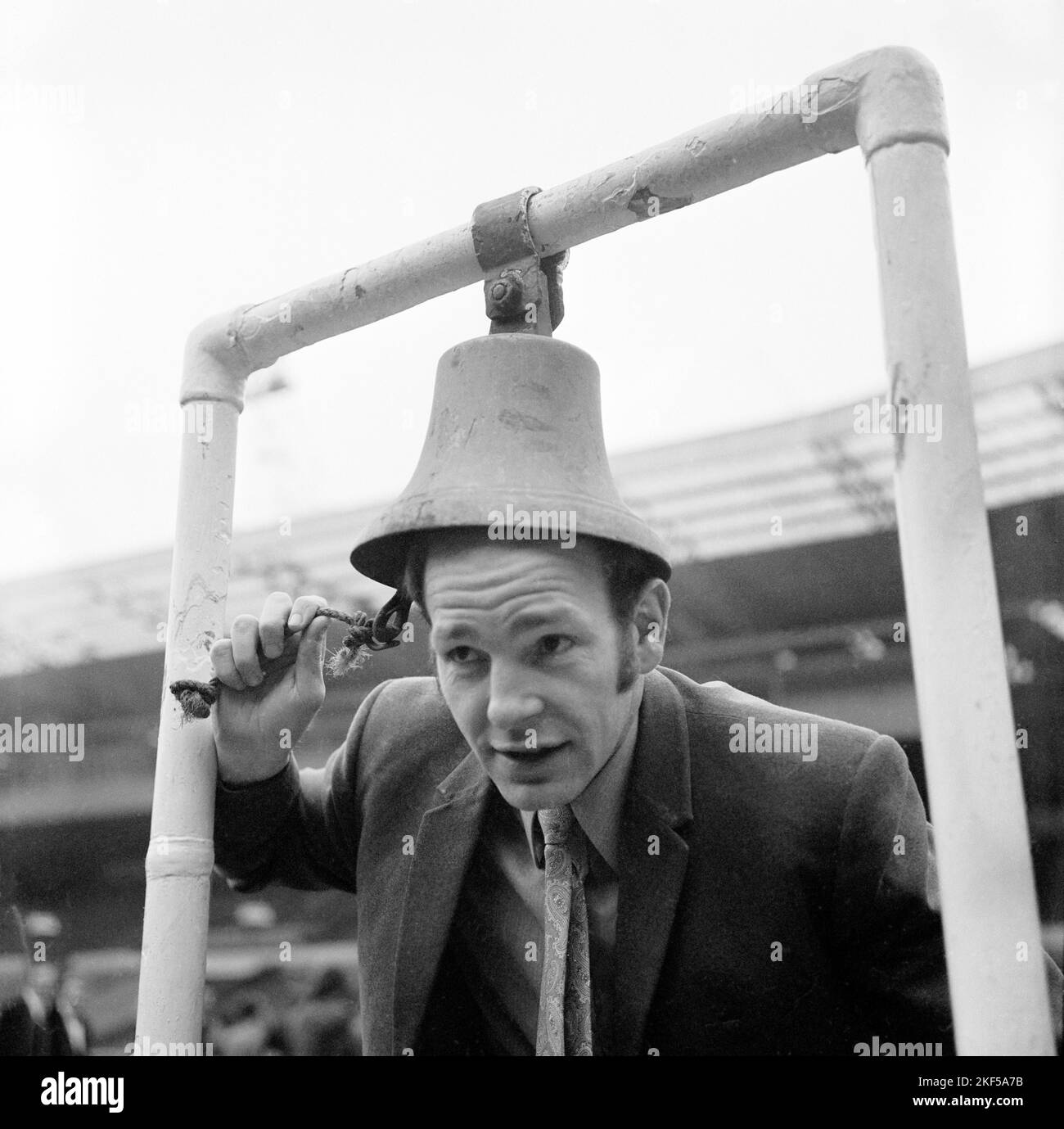 Aston Villa's Andy Lochhead fools around with the greyhound track bell ...