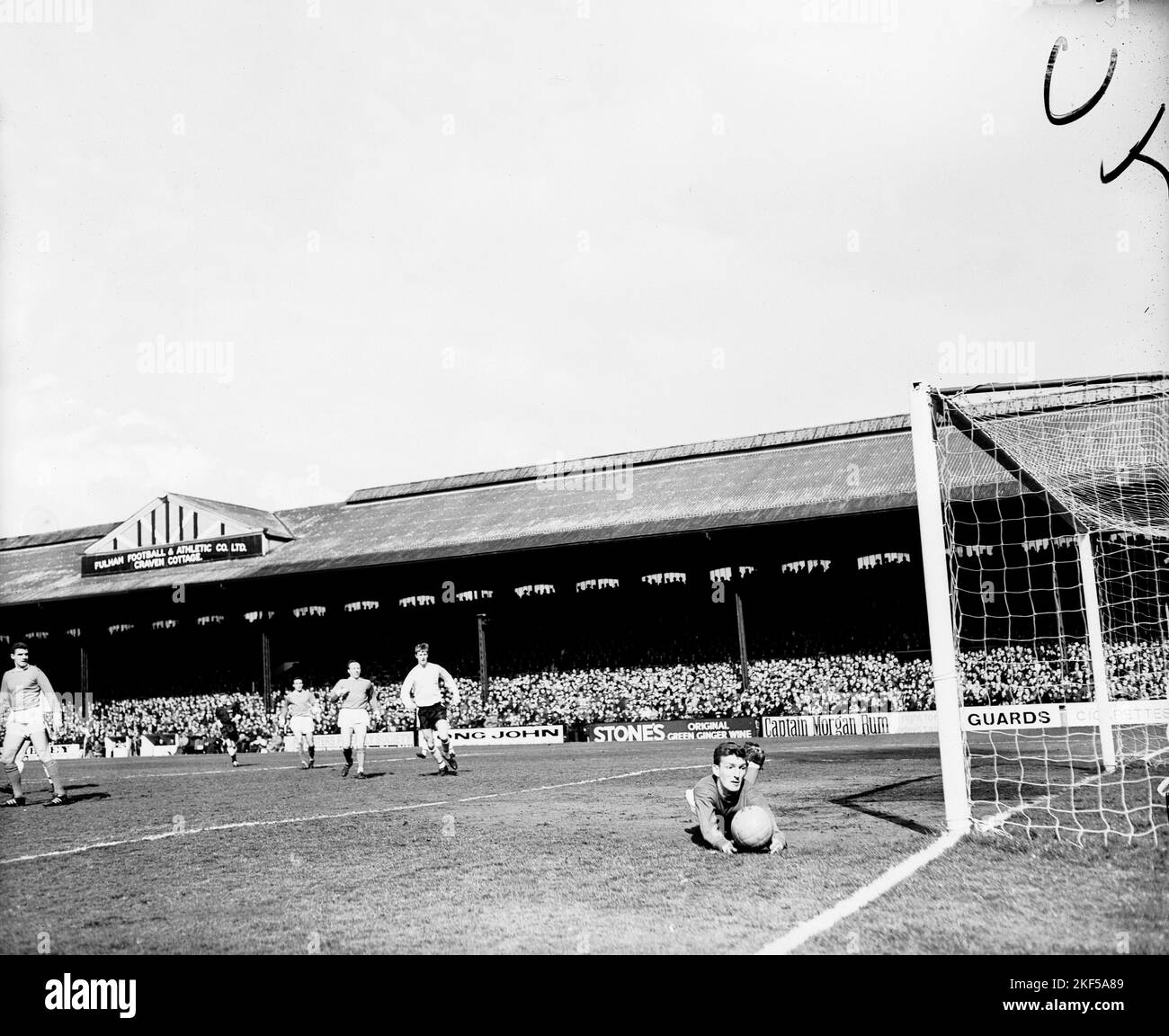 Manchester United goalkeeper Alex Stepney (r) makes a diving save Stock ...
