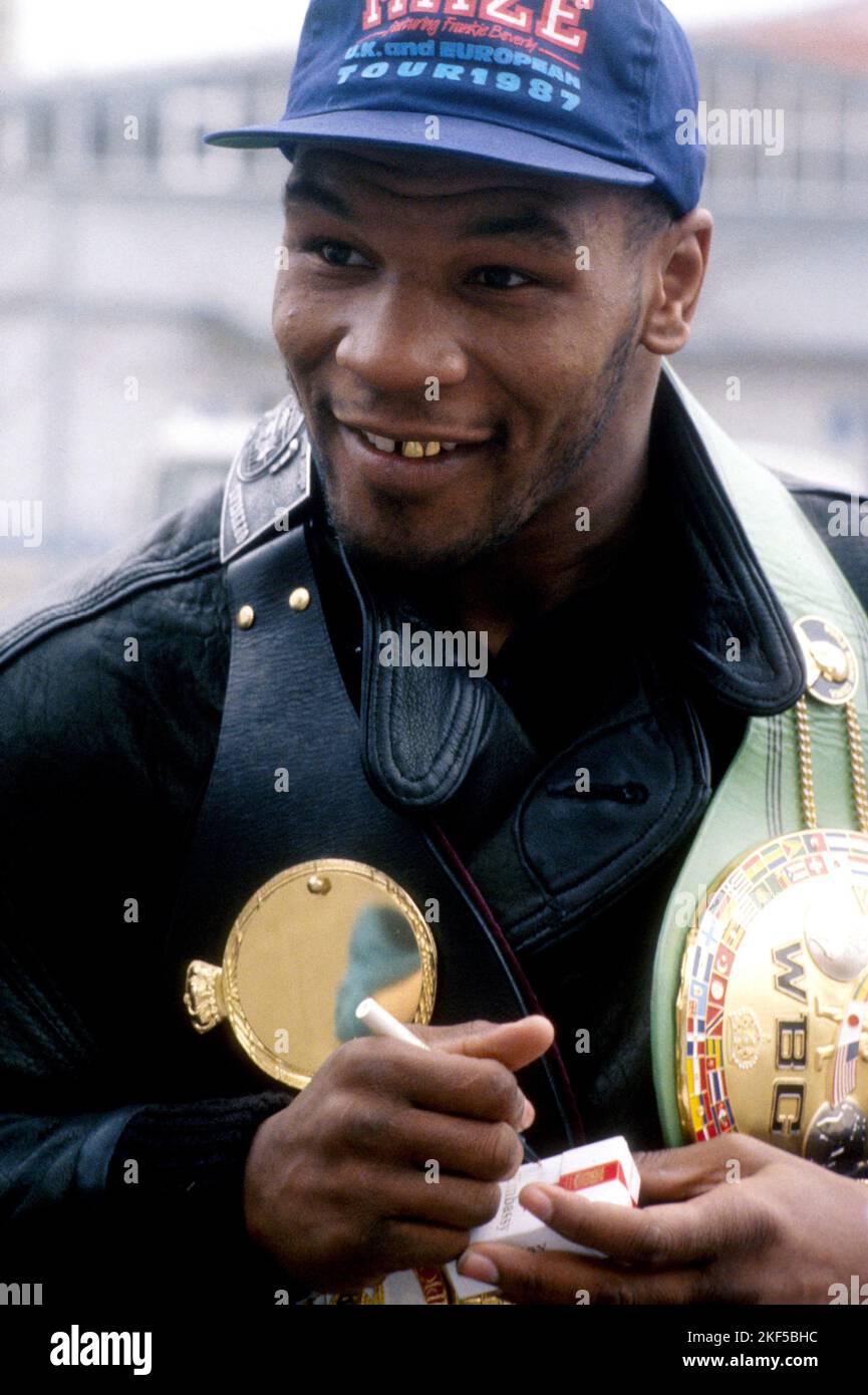 World Heavyweight Champion Mike Tyson signs an autograph on a cigarette ...