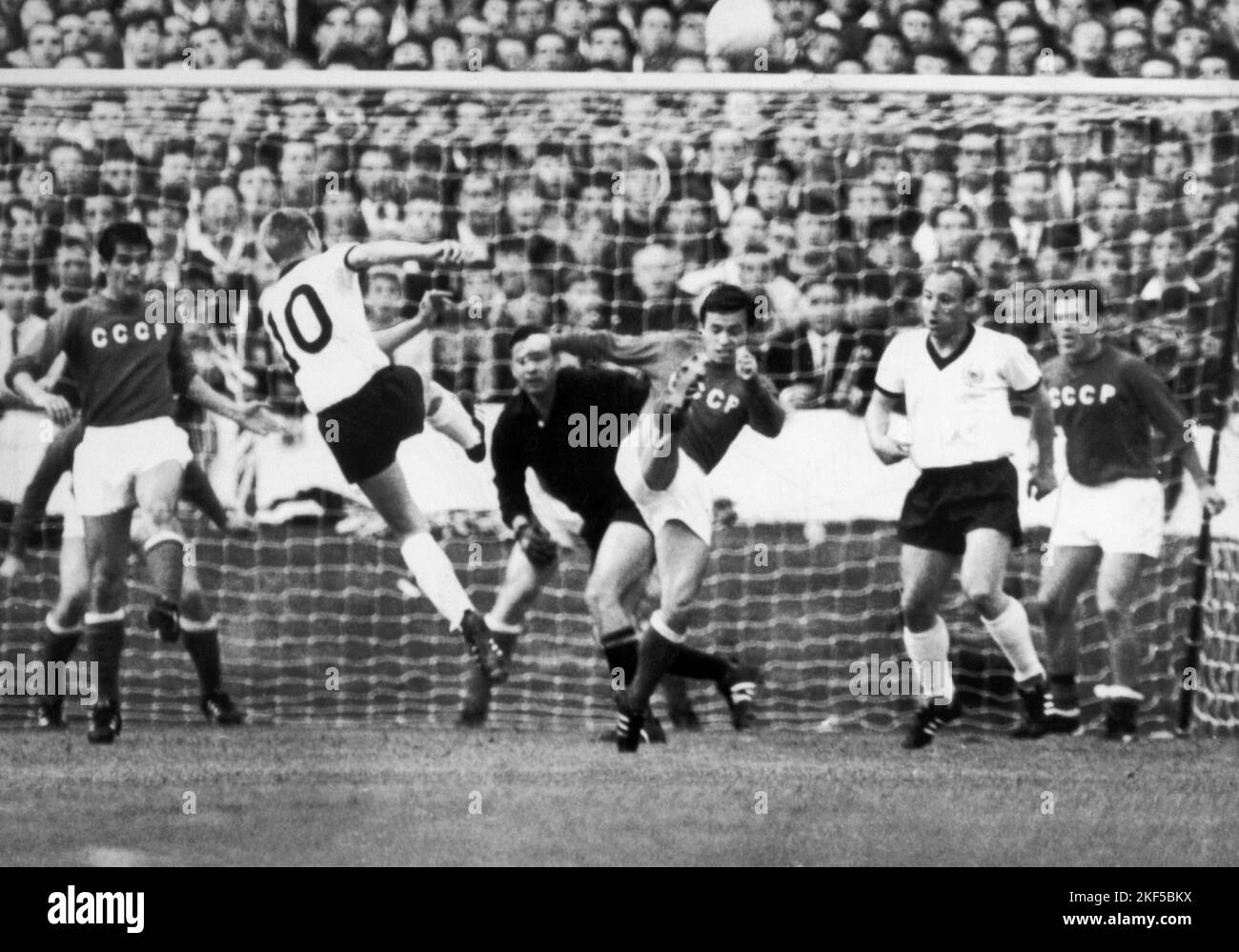 West Germany's Sigfried Held (second l) shoots wildly over the bar ...