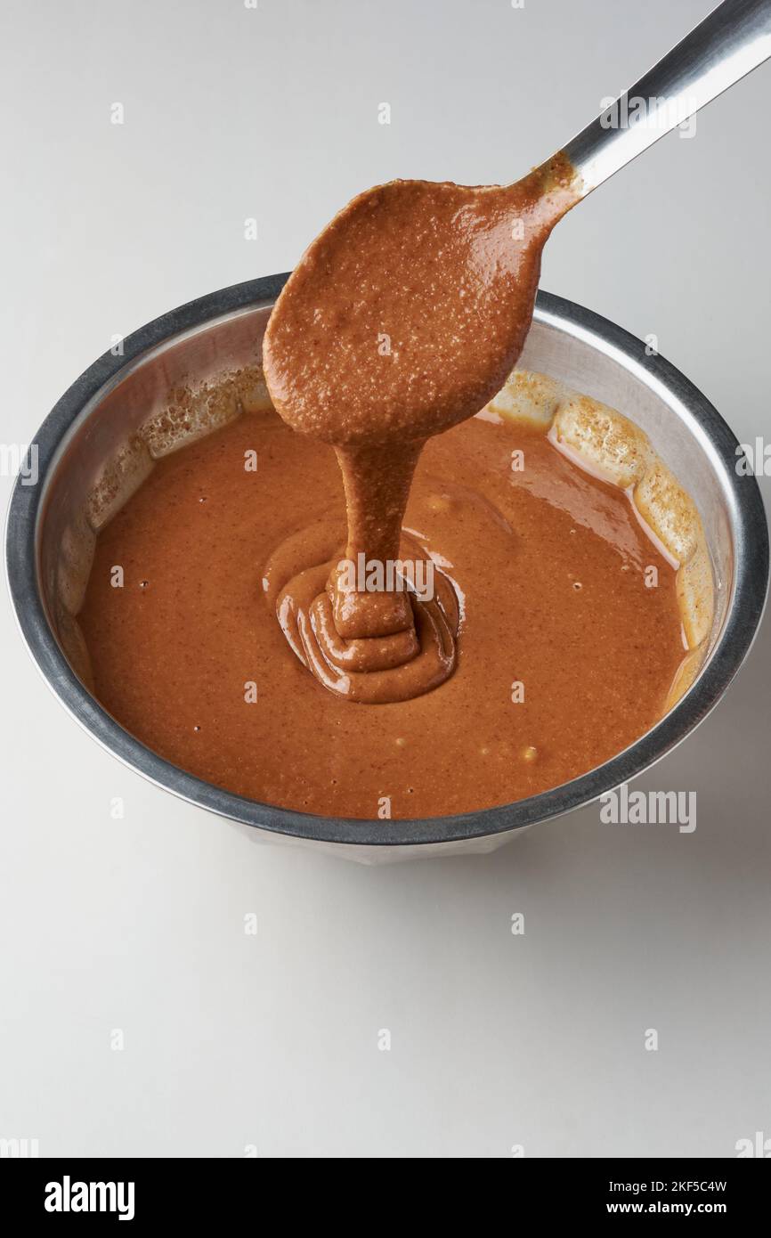 chocolate caramel cream, beating with a spoon, oil cake mixture closeup ...
