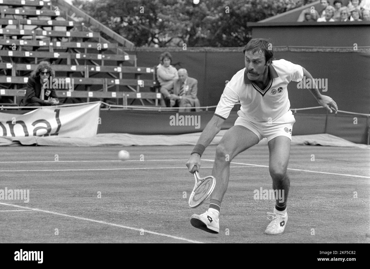John Newcombe stoops to return the ball Stock Photo - Alamy