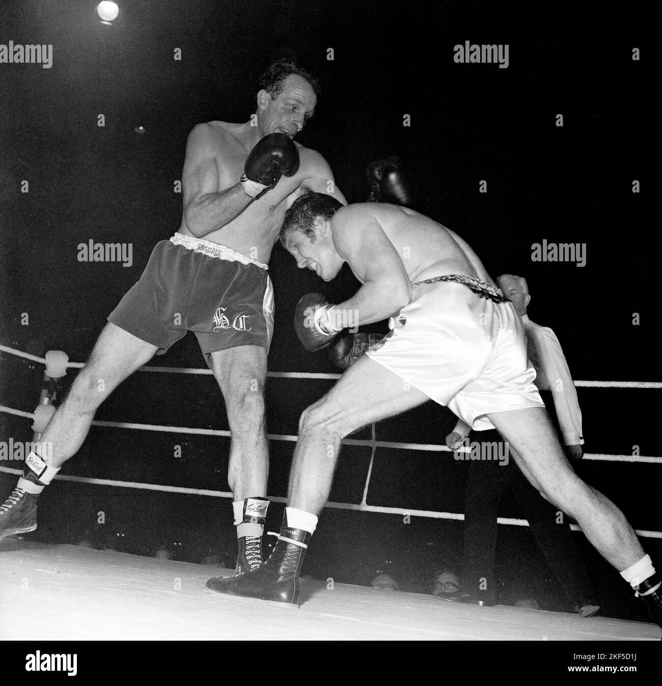 Billy Walker (r) ducks as Henry Cooper (l) throws a left at close ...