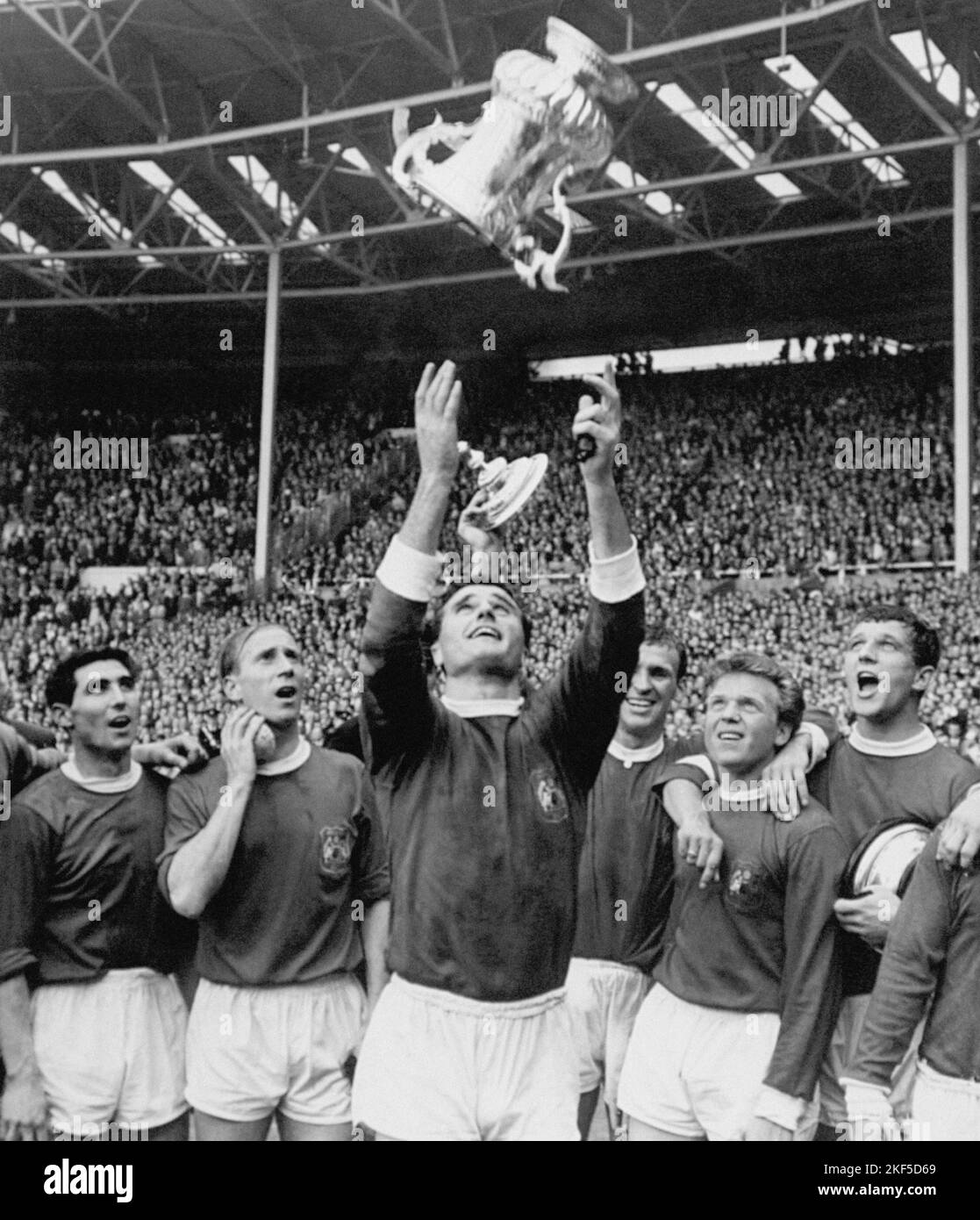 Manchester United's Noel Cantwell (c) throws the FA Cup into the air ...