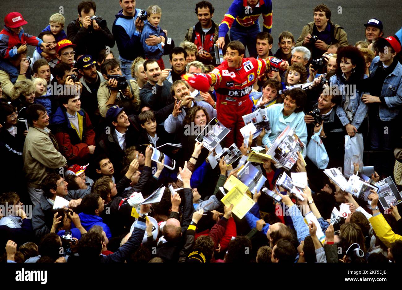 Britain's Nigel Mansell throws his hat into the crowd at Silverstone ...