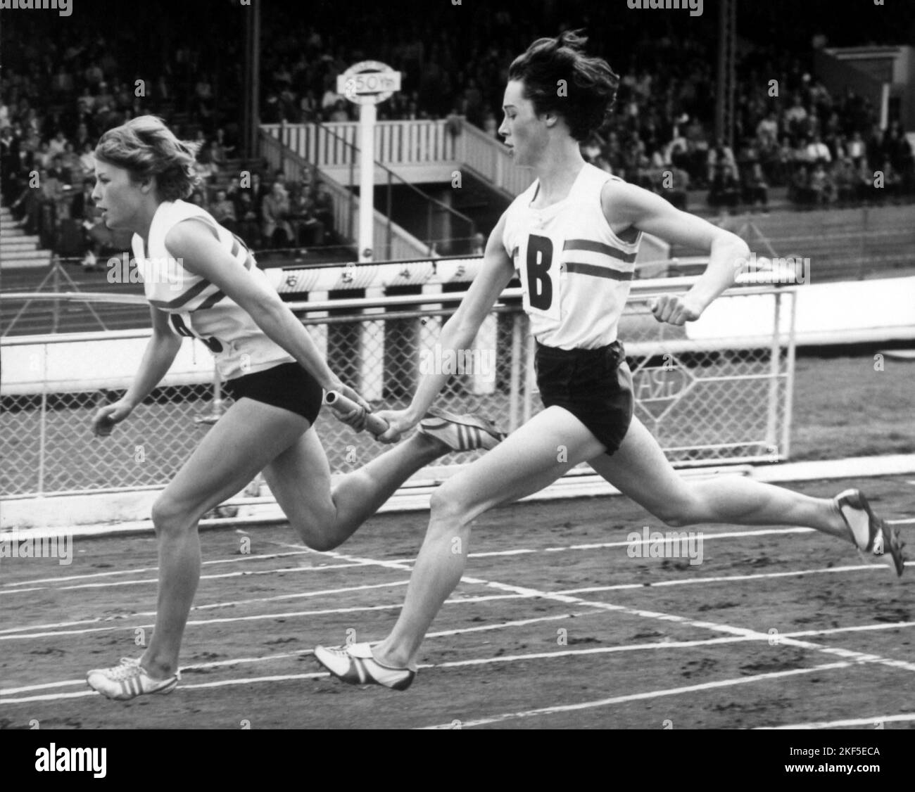Great Britain's J Smart (r) hands the baton to teammate Mary Bignal (l ...