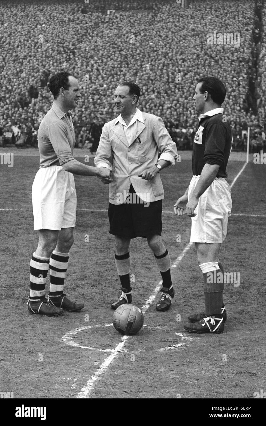 (L-R) Rest of Europe captain Johnny Carey shakes hands with referee ...
