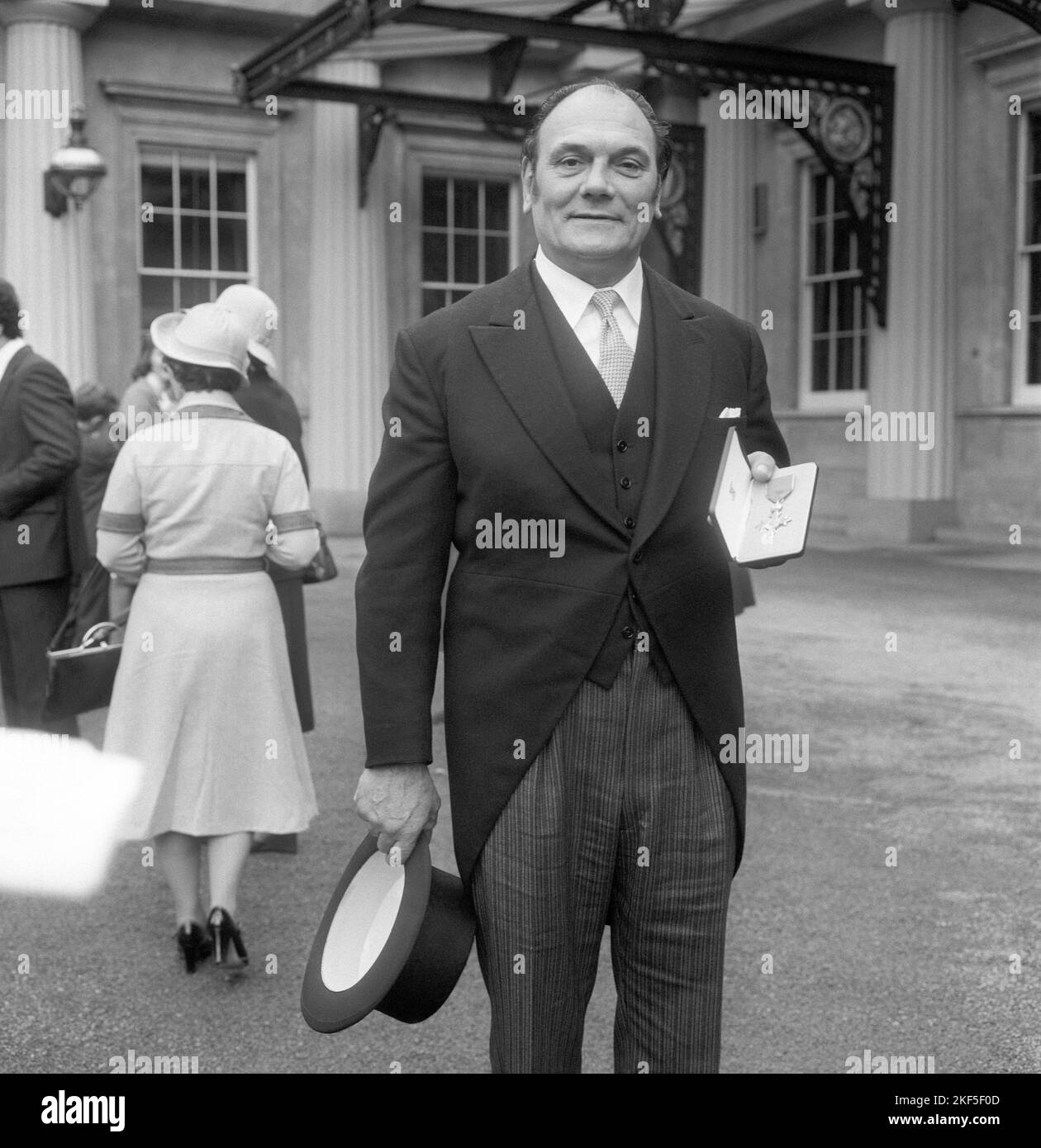 Boxing referee Harry Gibbs shows off his OBE after his investiture ...