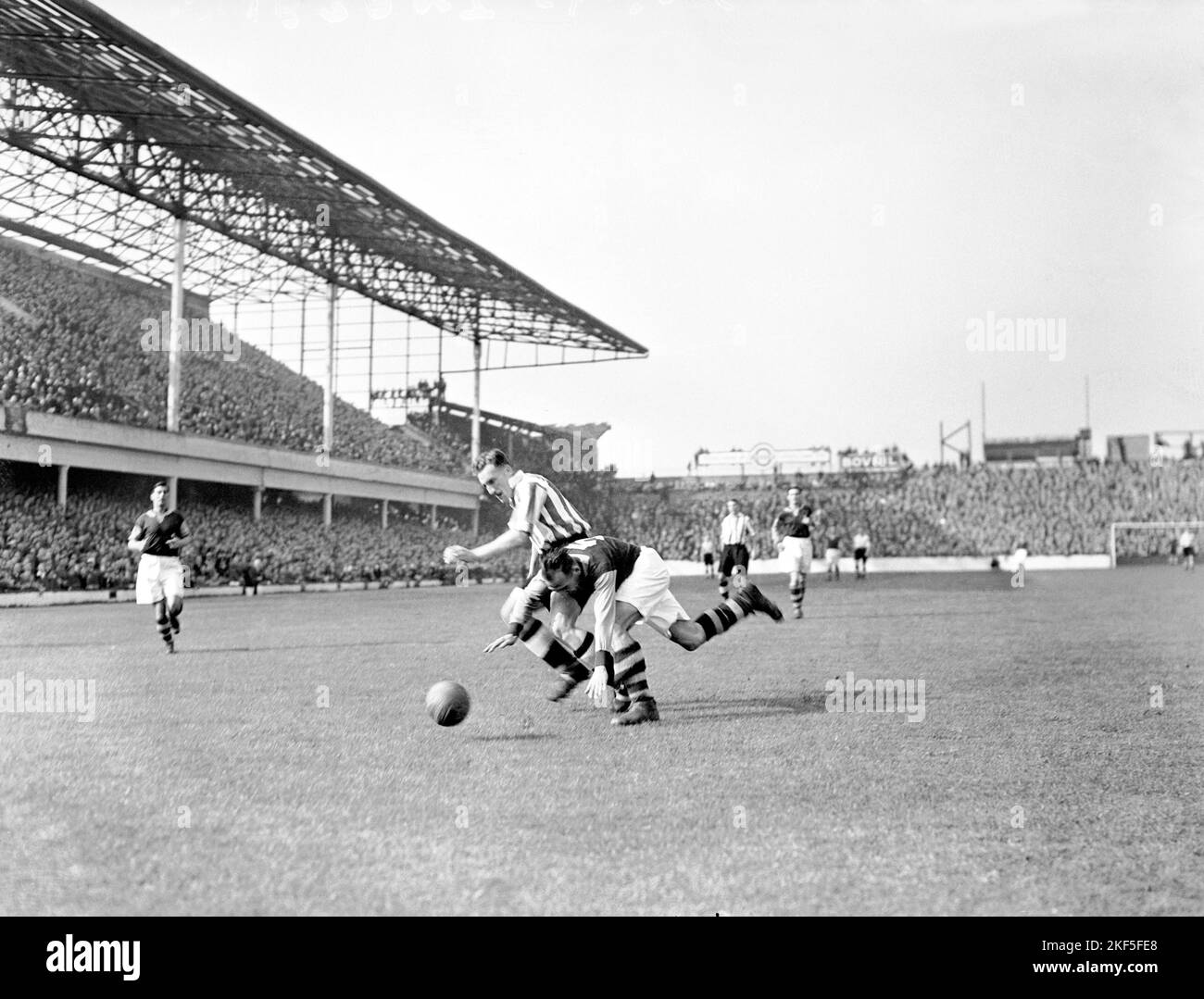 West Ham United's Ted Fenton (r) is nudged off the ball by Brentford's ...