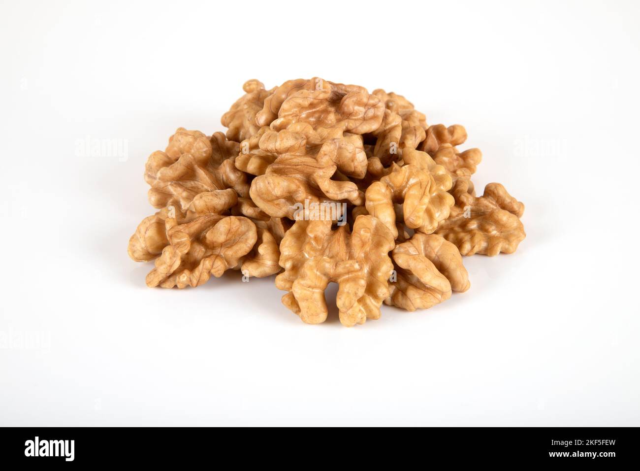 A group of peel walnuts on a white background Stock Photo - Alamy