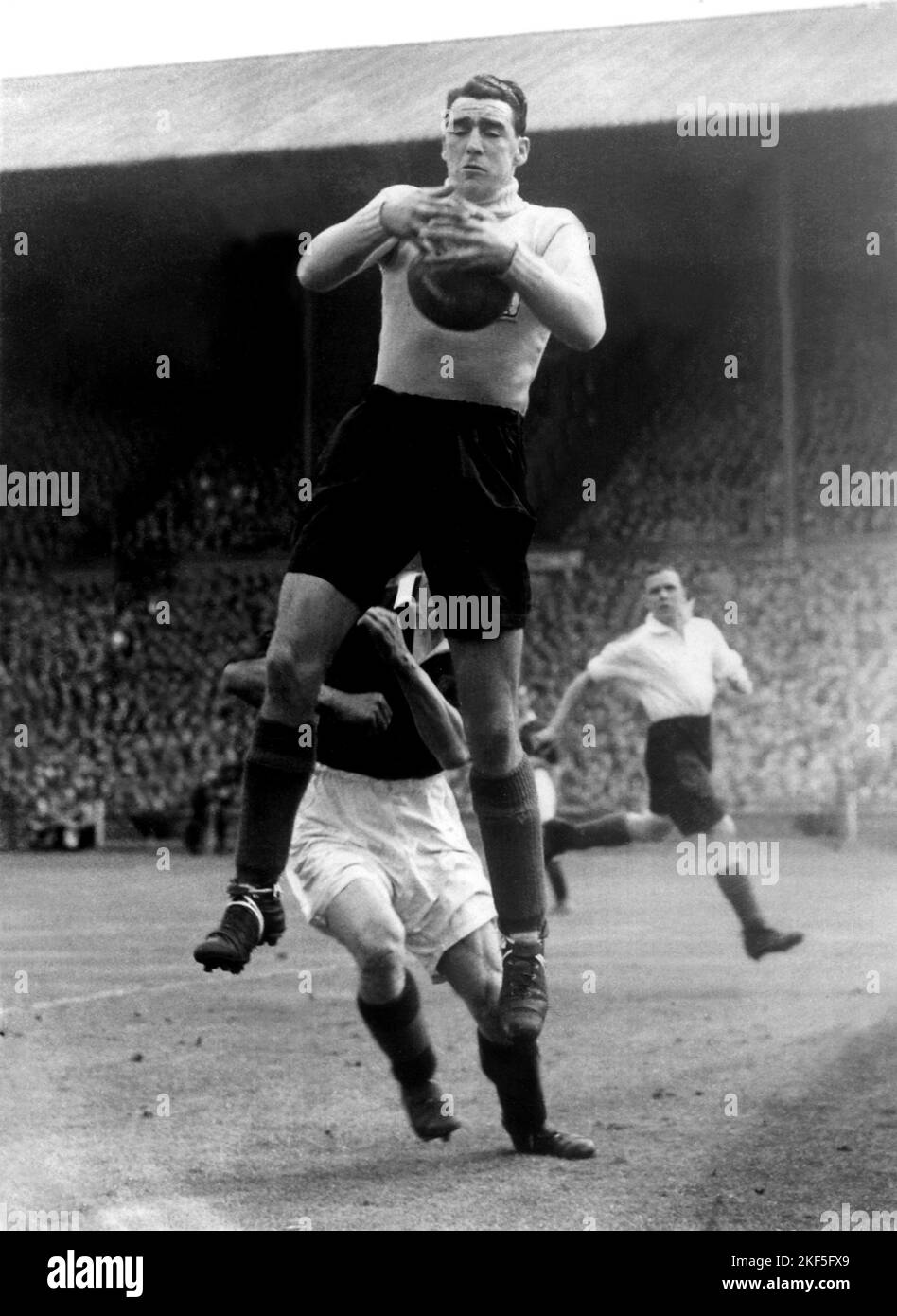 England goalkeeper Frank Swift leaps to deal with a cross, intended for ...