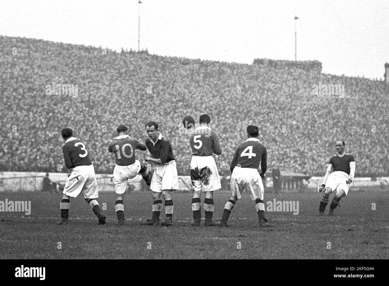 Aston Villa's Bob Iverson (r) tries to chip a free kick over the ...
