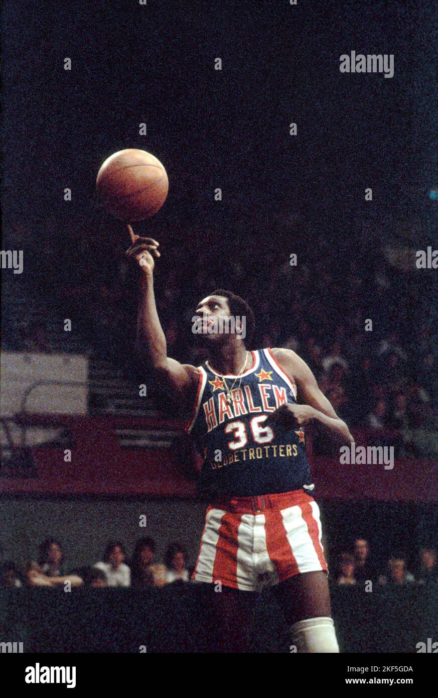 A Harlem Globetrotter performs the traditional ball-spinning Stock ...